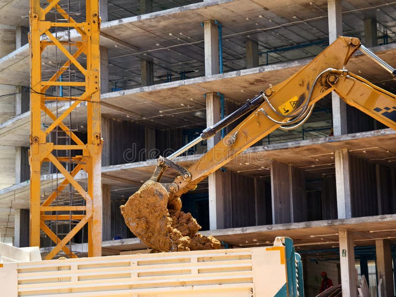 Excavator Loads Ground into a Dump Truck at a Construction Site Stock ...