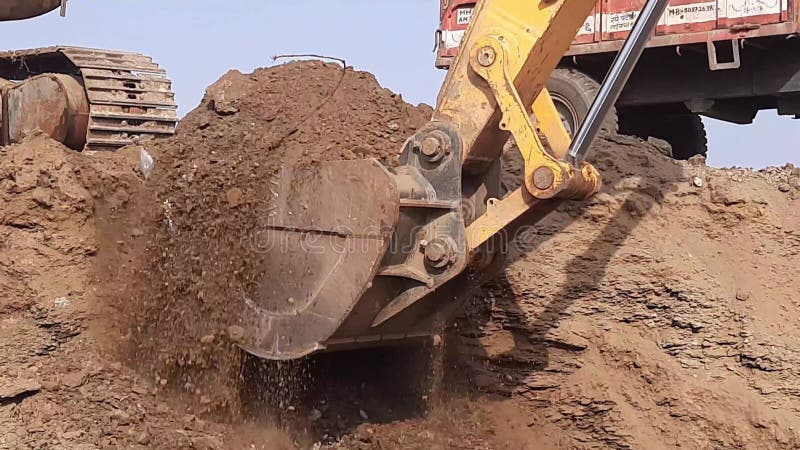 An Excavator Loads Moorum Soil into a Tractor at Construction Land ...