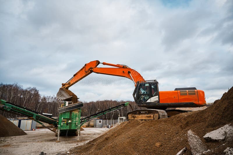 Excavator Loads Soil in Mobile Crushing and Sorting Complex Stock Photo ...