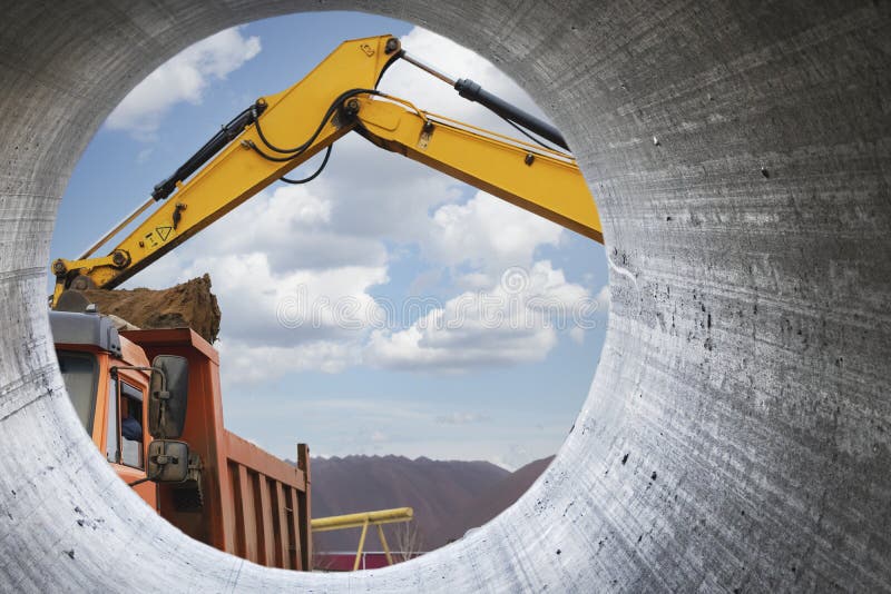 An Excavator Loads Soil or Sand into a Dump Truck. Pit Development ...
