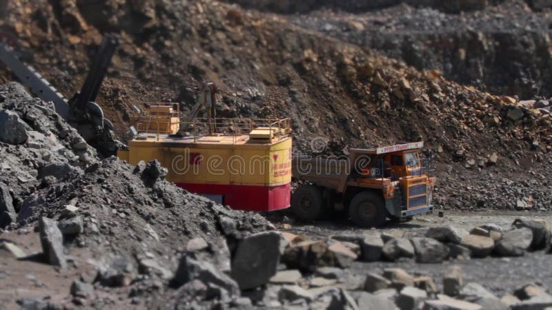 Excavator Loads a Stone in the Heavy Truck in the Quarry Mining Granite ...