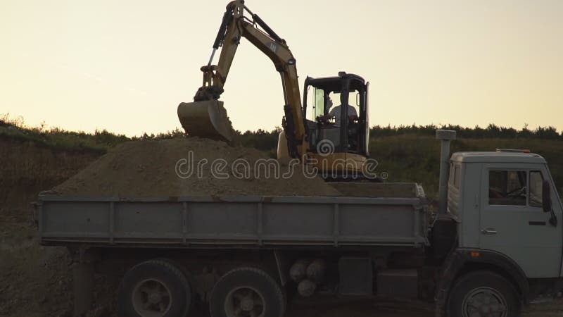 Excavator loads a truck stock video. Video of construction - 136882507