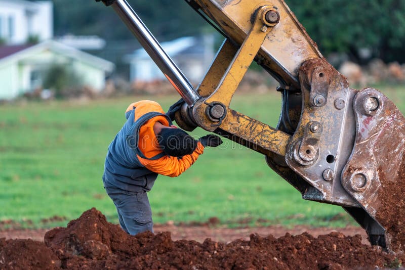 Excavator Maintenance and Repair Operator Doing Repairs and Maintenance ...