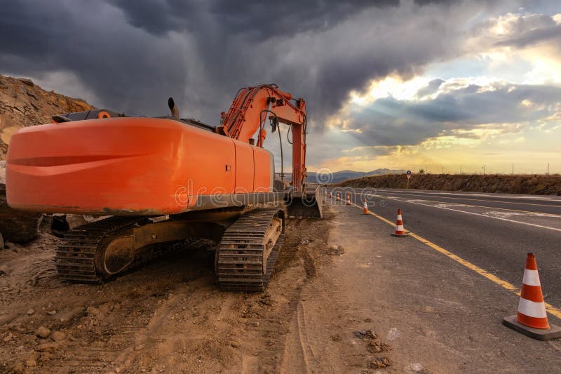 Excavator Making Earth Movements for the Construction of a Road Stock ...