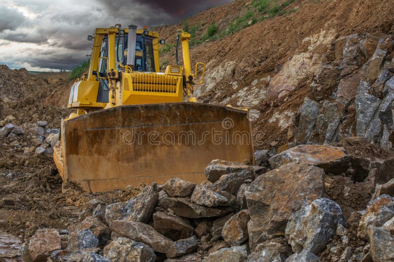 Excavator Making Earth Movements for the Construction of a Road Stock ...