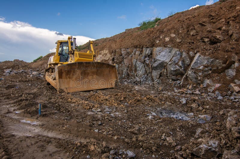 Excavator Making Earth Movements for the Construction of a Road Stock ...