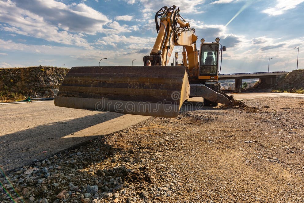 Excavator Making Earth Movements for the Construction of a Road Stock ...