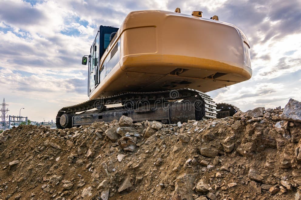 Excavator Making Earth Movements for the Construction of a Road Stock ...