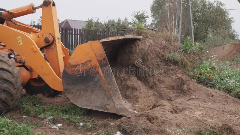An Excavator is Moving Dirt Efficiently at a Construction Site during ...