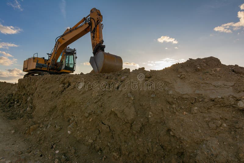 Excavator Moving Dirt and Sand at a Construction Site Stock Photo ...