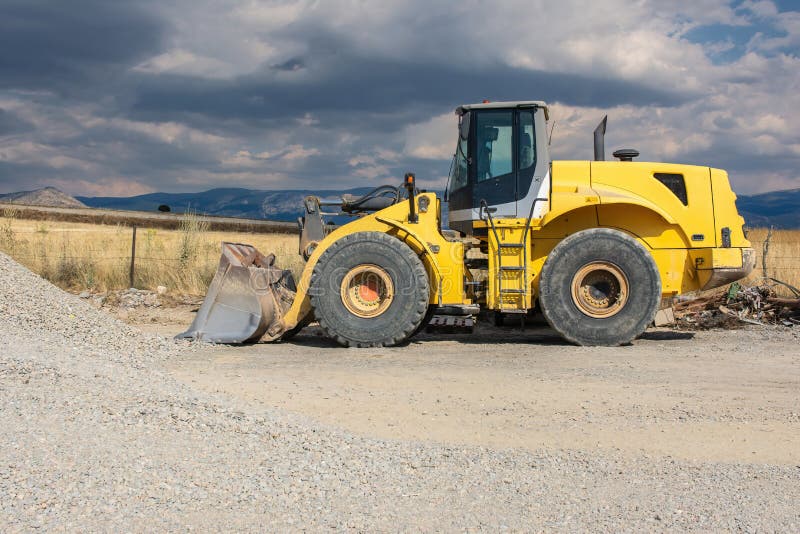 Excavator Moving Dirt and Sand at a Construction Site Stock Photo ...