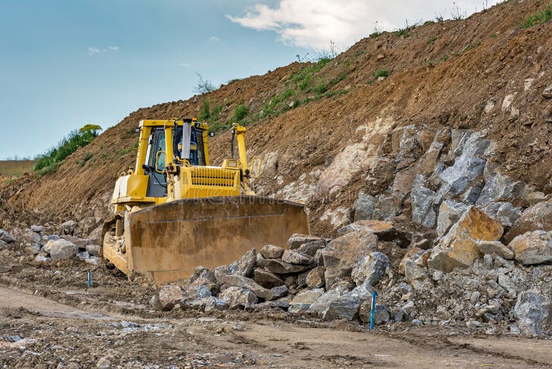 Excavator Moving Granite and Other Rocks in the Construction of a Road ...