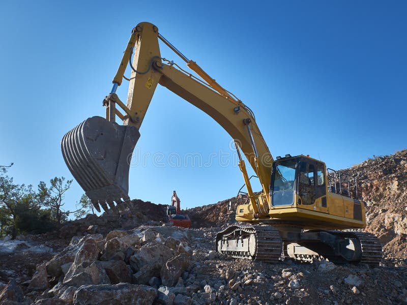 Excavator Scoop Moving A Rock Boulders During Road Construction On The ...