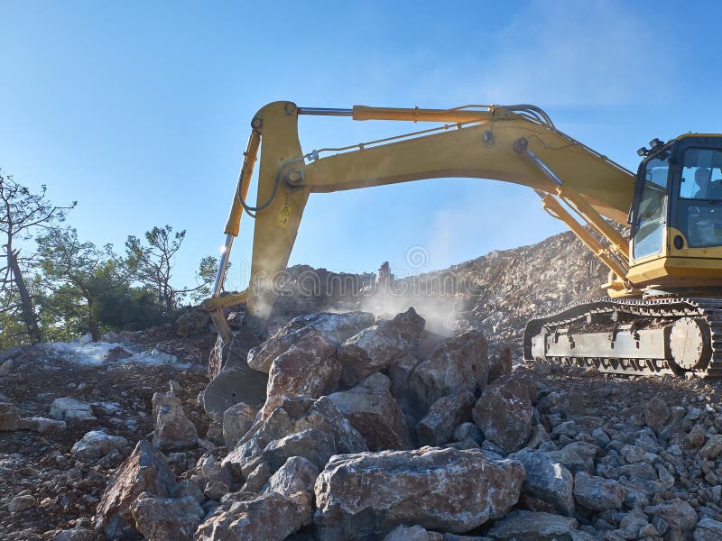Excavator Moving Soil with Lots of Dust during Excavation Works on the ...