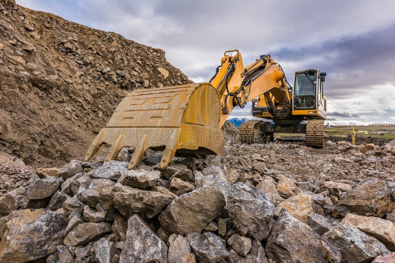 Excavator Moving Rocks on a Site for Processing and Transformation ...