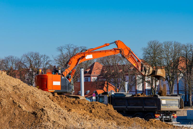 Excavator Moving Soil at a Construction Site in Bright Daylight Stock ...