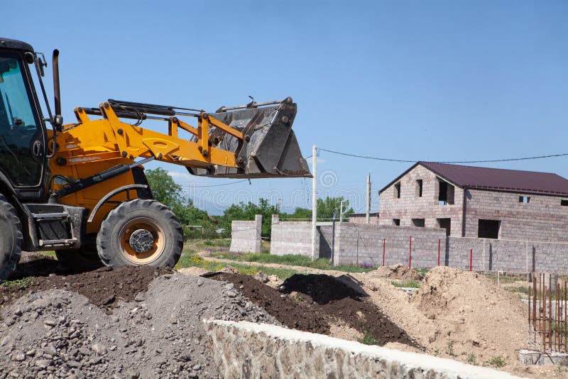 Excavator and New Building in the Field. Build a House Stock Photo ...