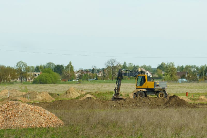 Excavator Operating on a Construction Site during an Early Morning ...