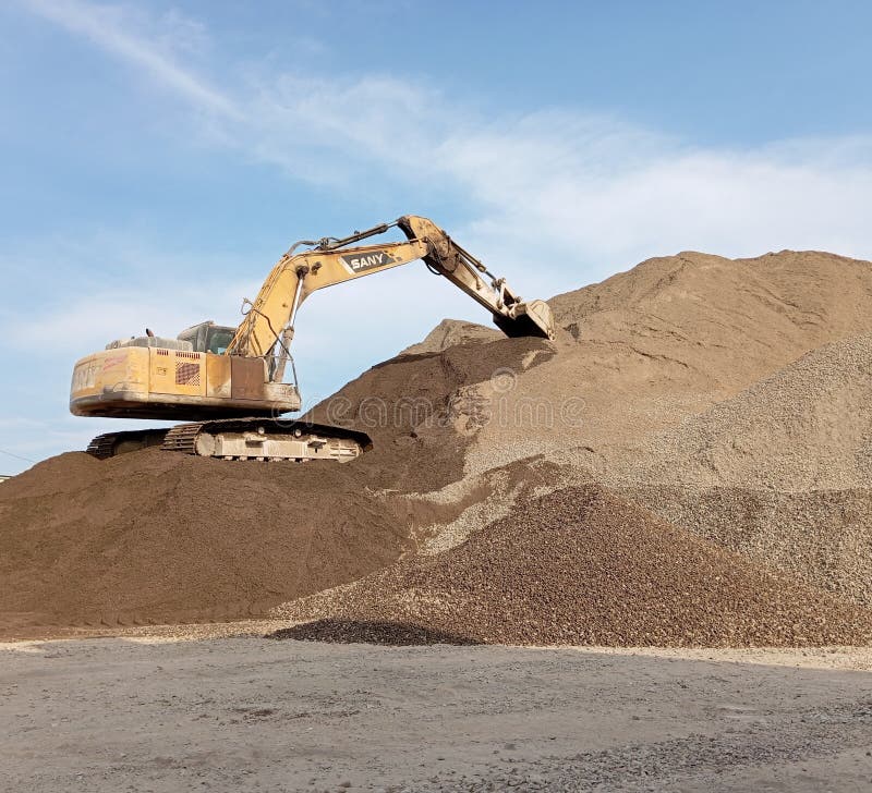 Excavator Operating at the Mine Site with a Blue Sky Background ...