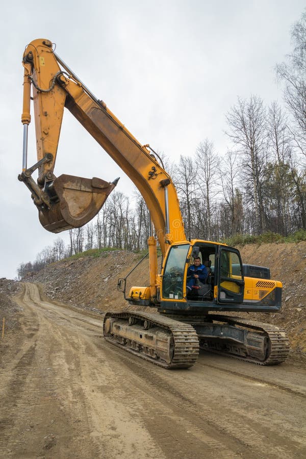 Excavator in operation editorial photography. Image of rocky - 103299157