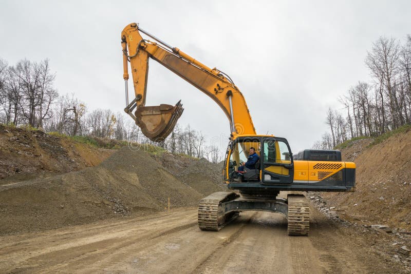 Excavator in operation editorial stock photo. Image of caterpillar ...