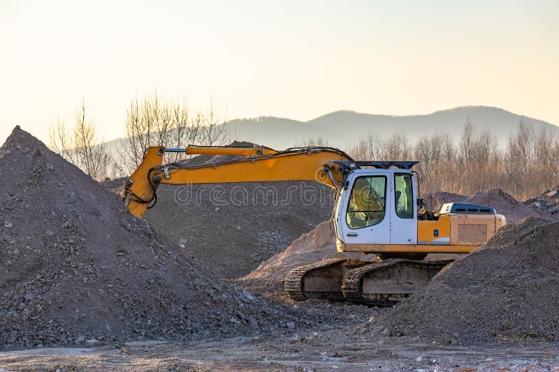 An Excavator among Piles of Clay. Stock Image - Image of growth ...