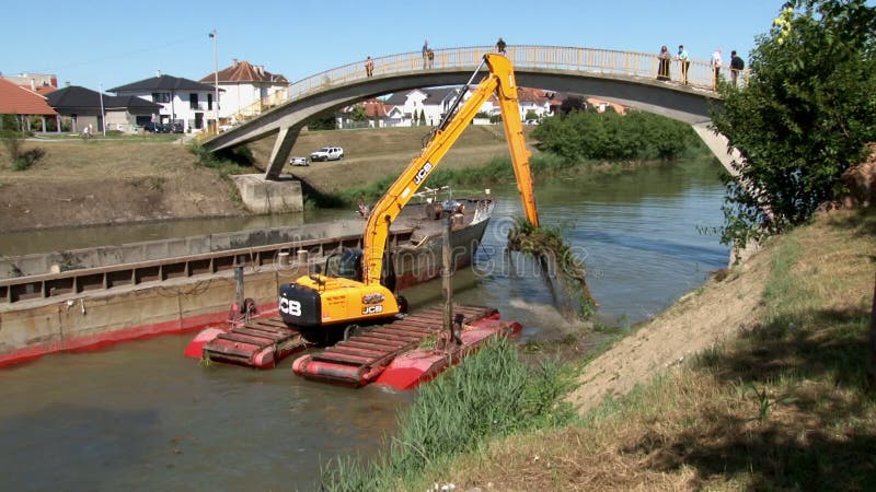An Excavator on the Pontoon for Cleaning the River Bottom is Waiting ...