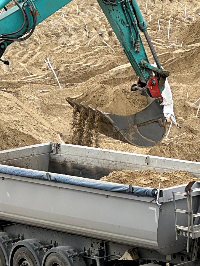 Excavator Pours Sand from the Bucket into the Back Stock Photo - Image ...