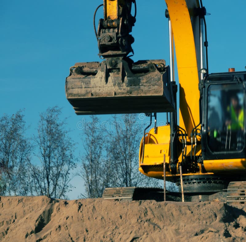 Excavator in the Process of Leveling the Slope of the Road Stock Photo ...