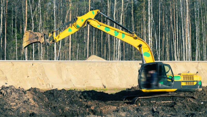 Excavator in the Process of Leveling the Slope of the Road Stock Image ...