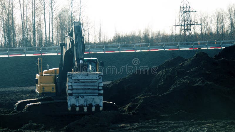 Excavator in the Process of Leveling the Slope of the Road Stock Image ...
