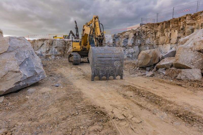 Excavator in a Quarry Extracting Stone Stock Photo - Image of excavator ...