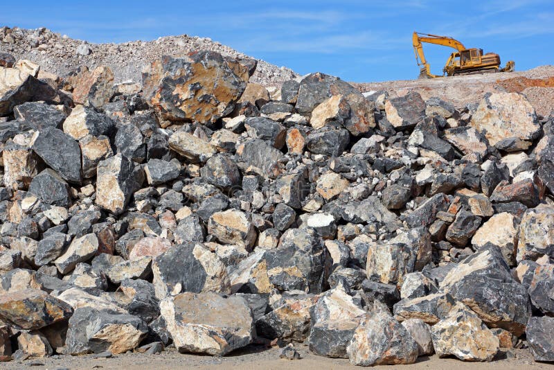 Excavator on rock pile stock photo. Image of industry - 36966546
