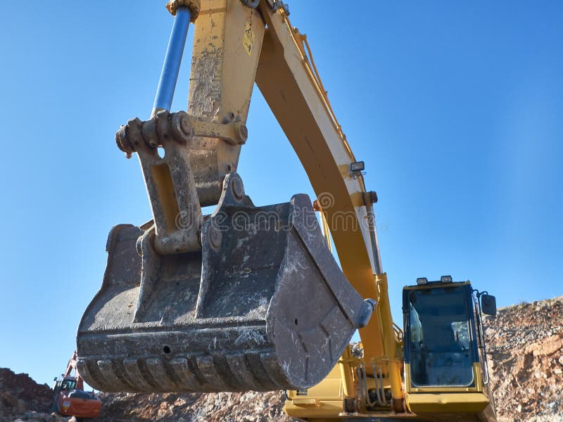 Excavator Scoop Moving a Rock Boulders during Road Construction on the ...