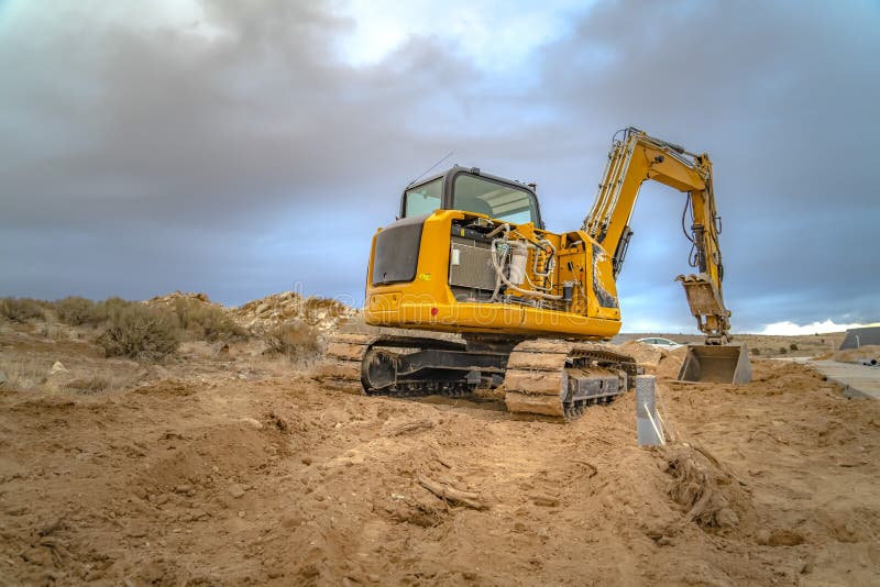 Excavator Scooping and Leaving Tread Marks on Dirt Stock Image - Image ...