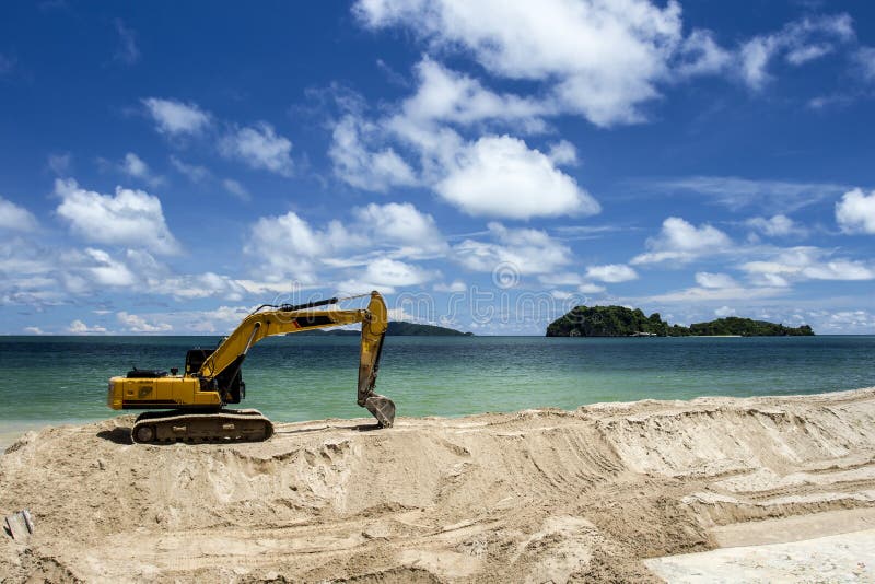 Excavator is Scooping Up Sand on the Beach with Sky, Sea and Island ...