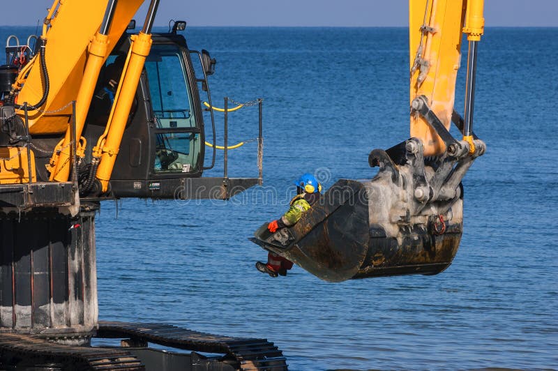 EXCAVATOR the SEA stock image. Image of excavator, kolobrzeg - 85794537