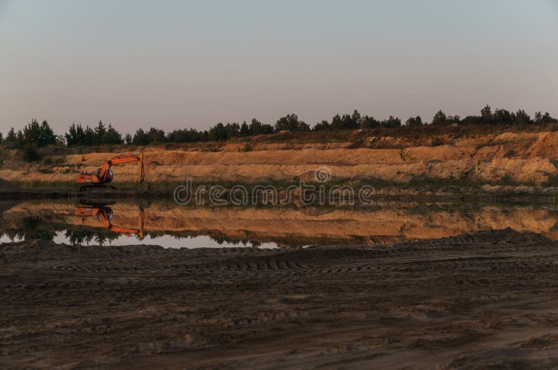 Excavator on the Shore of a Sand Pit Turning into a Pond Editorial ...