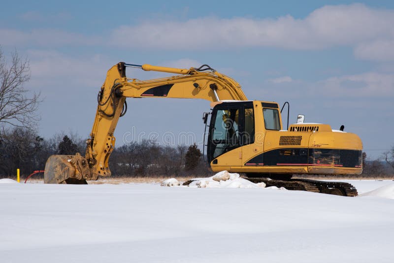 Excavator in the snow stock photo. Image of yellow, hydraulic - 211114106