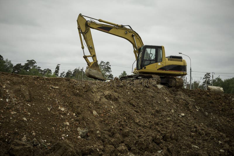 Excavator stock image. Image of cloud, hill, yellow, construction ...