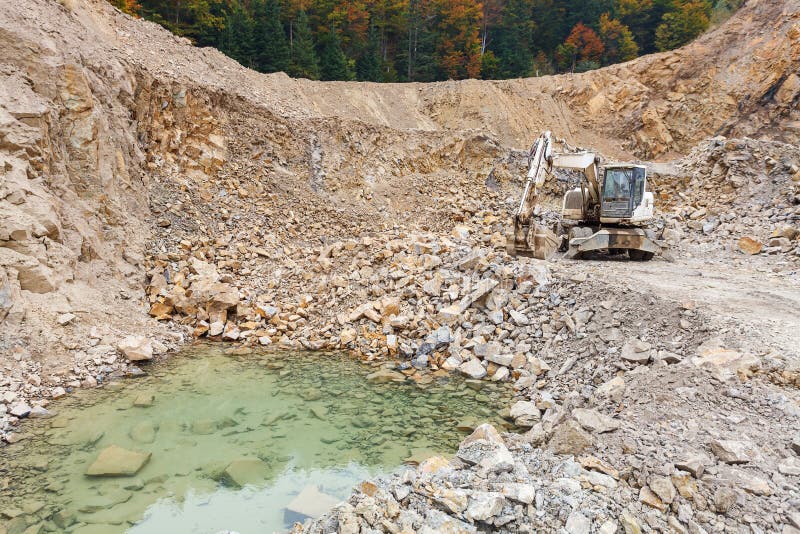 Excavator in stone-pit stock image. Image of equipment - 62499089