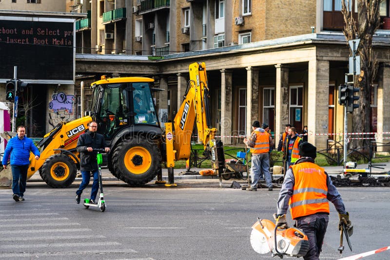 Excavator in Traffic. Industrial Equipment at Construction Site in ...