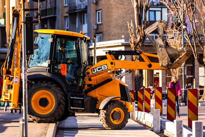 Excavator in Traffic. Industrial Equipment at Construction Site in ...