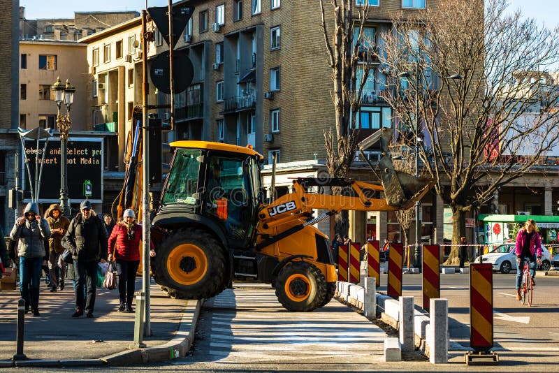 Excavator in Traffic. Industrial Equipment at Construction Site in ...