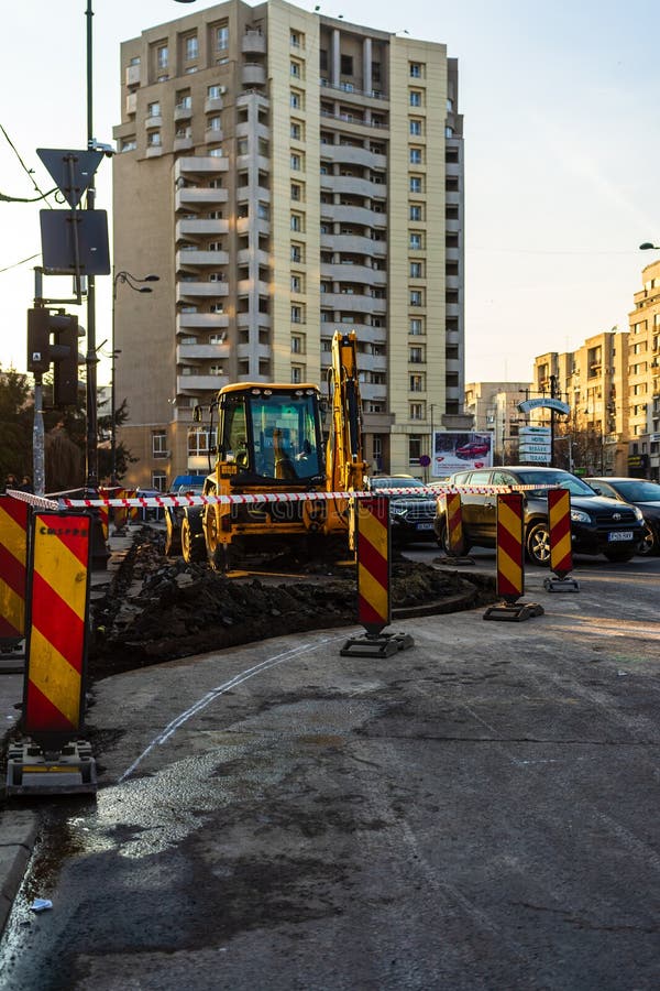 Excavator in Traffic. Industrial Equipment at Construction Site in ...