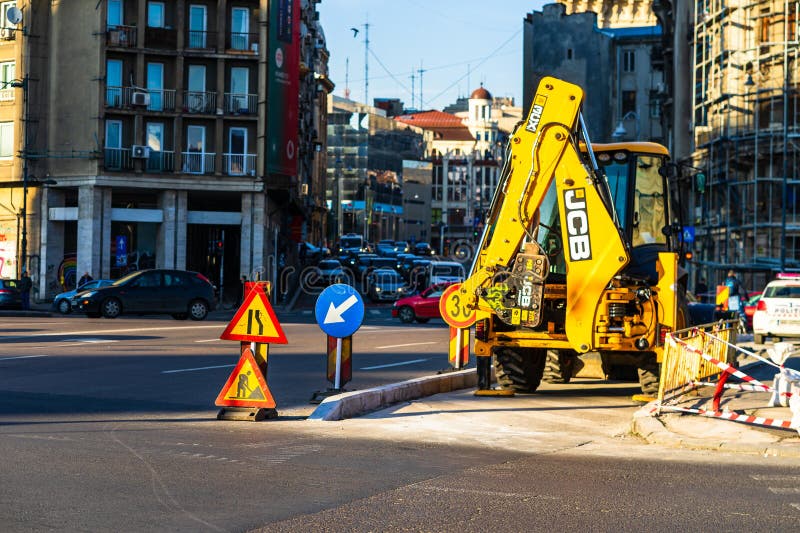 Excavator in Traffic. Industrial Equipment at Construction Site in ...