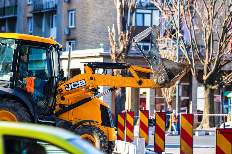 Excavator in Traffic. Industrial Equipment at Construction Site in ...