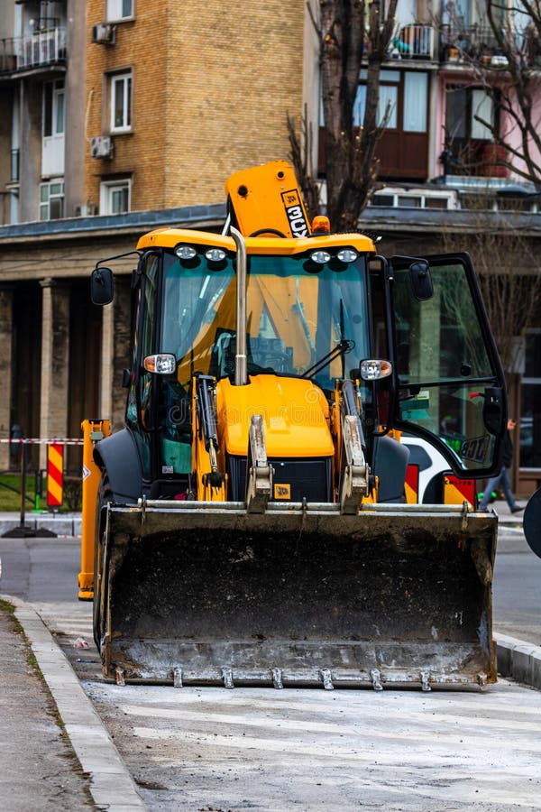 Excavator in Traffic. Industrial Equipment at Construction Site in ...