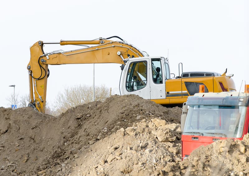 Excavator and truck stock photo. Image of development - 31139222
