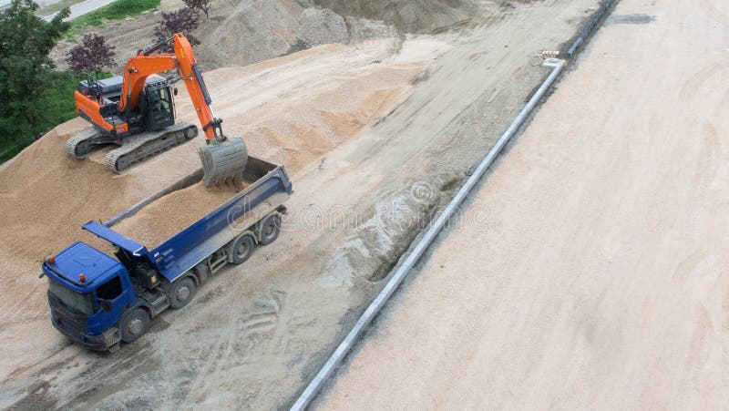 Excavator and Truck during Material Loading. Stock Photo - Image of ...